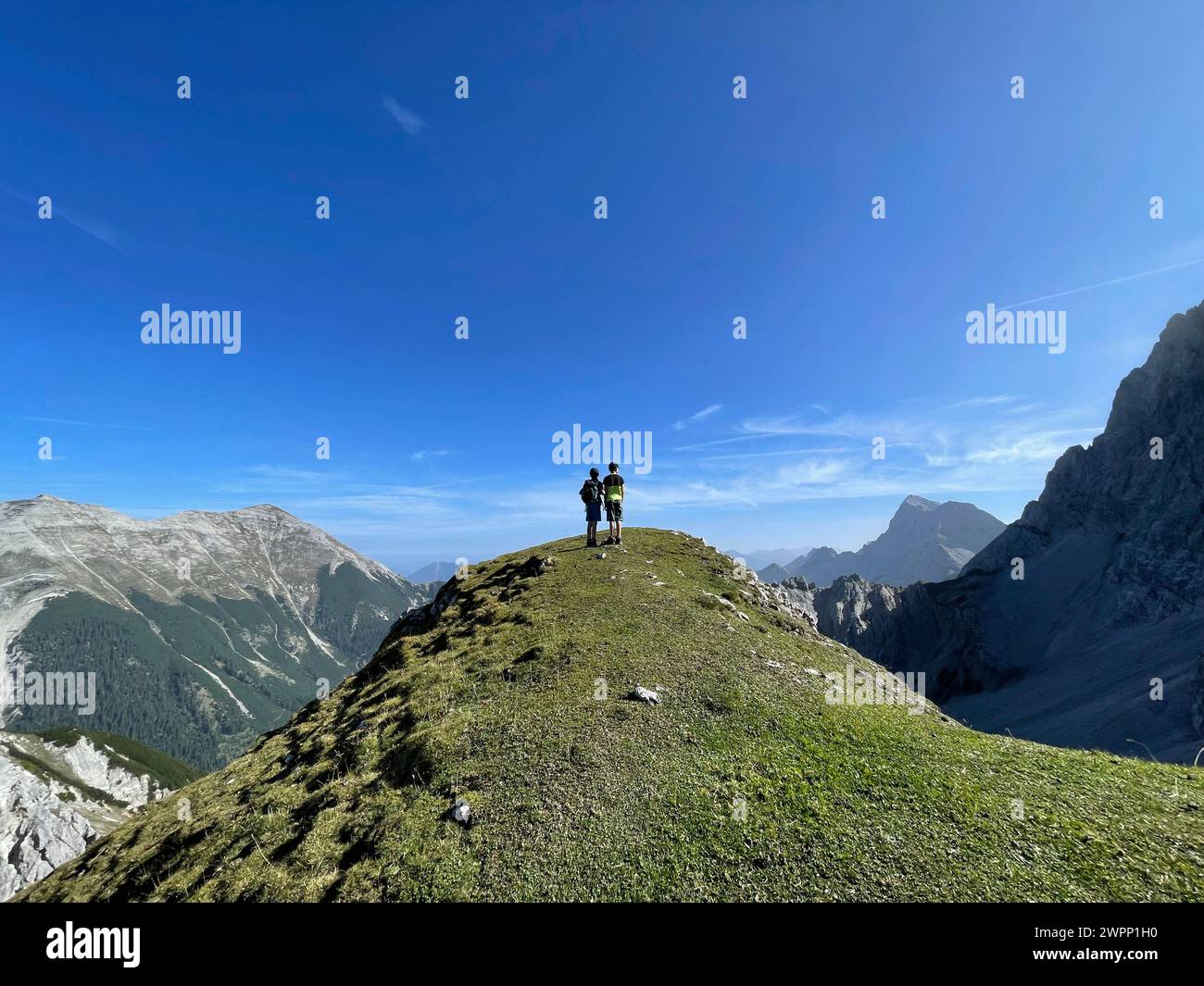 Two boys on hilltop with view into the distance hi-res stock ...