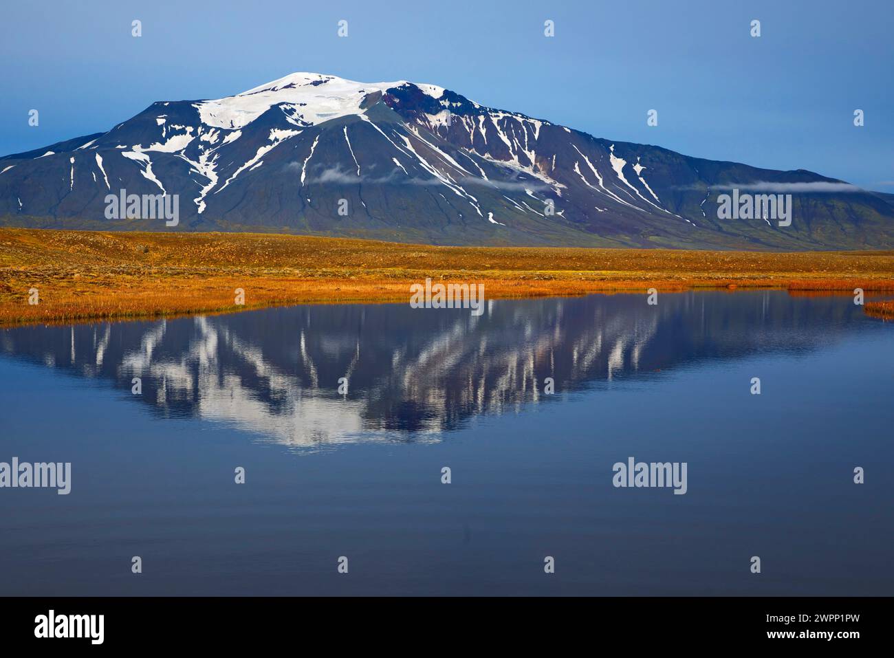 The summit of Snaefell in the north-east of Iceland is reflected in a ...