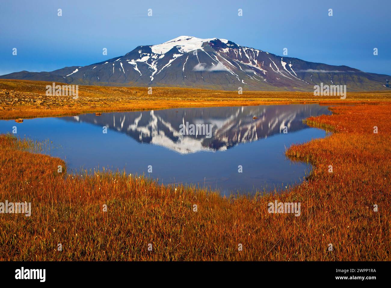 The summit of Snaefell in the north-east of Iceland is reflected in a ...