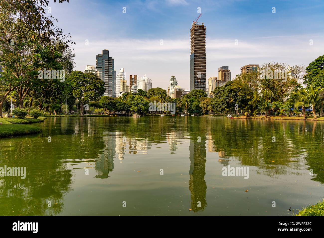 Lumphini Lake in Lumphini Park and the skyline of Bangkok, Thailand ...