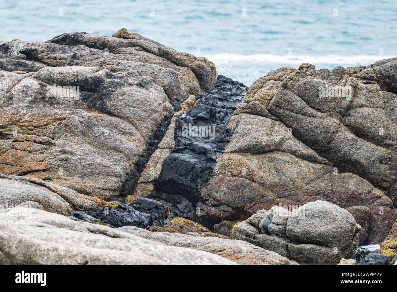 Dark colored igneous rock intruded into older, lighter colored granite ...