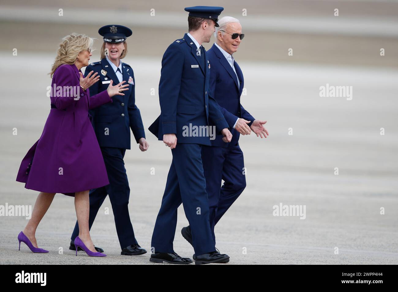 President Joe Biden, right, is escorted by Air Force Cpt. Eric Anderson ...