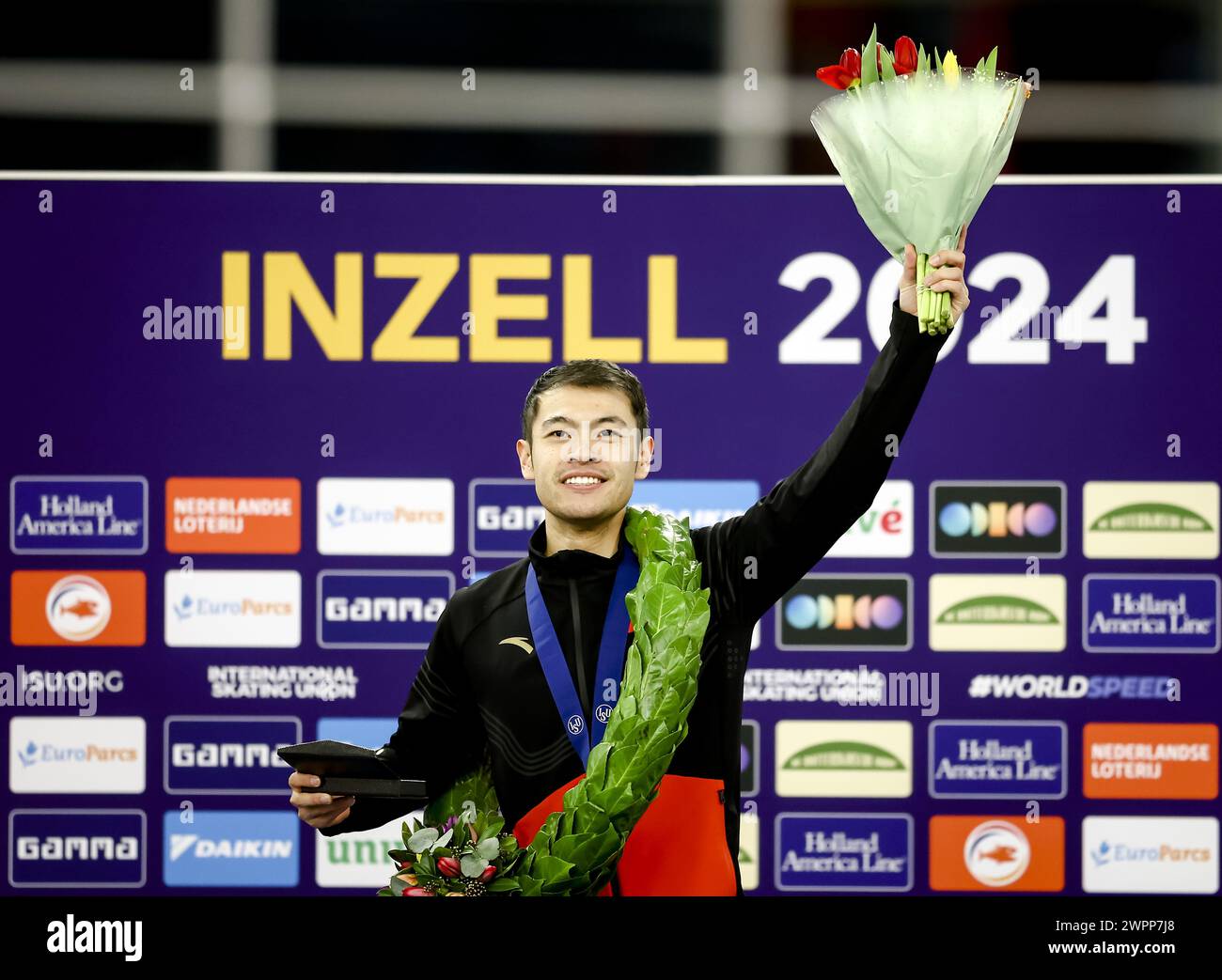 INZELL - Zhongyan Ning (CHN) with his gold medal on the podium after ...