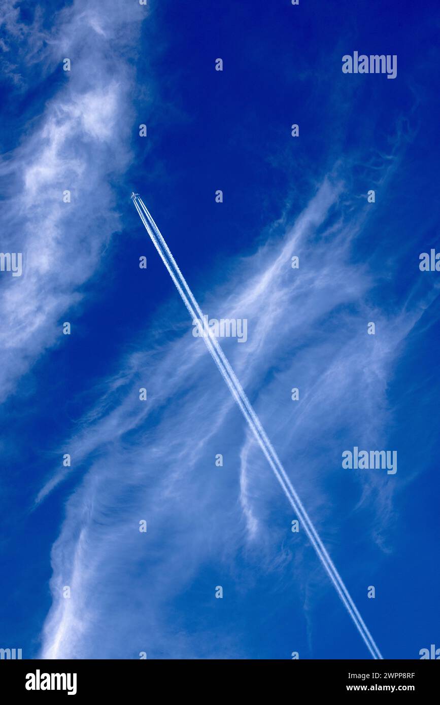 Cirrus clouds ruffled by the wind against a blue sky background ...