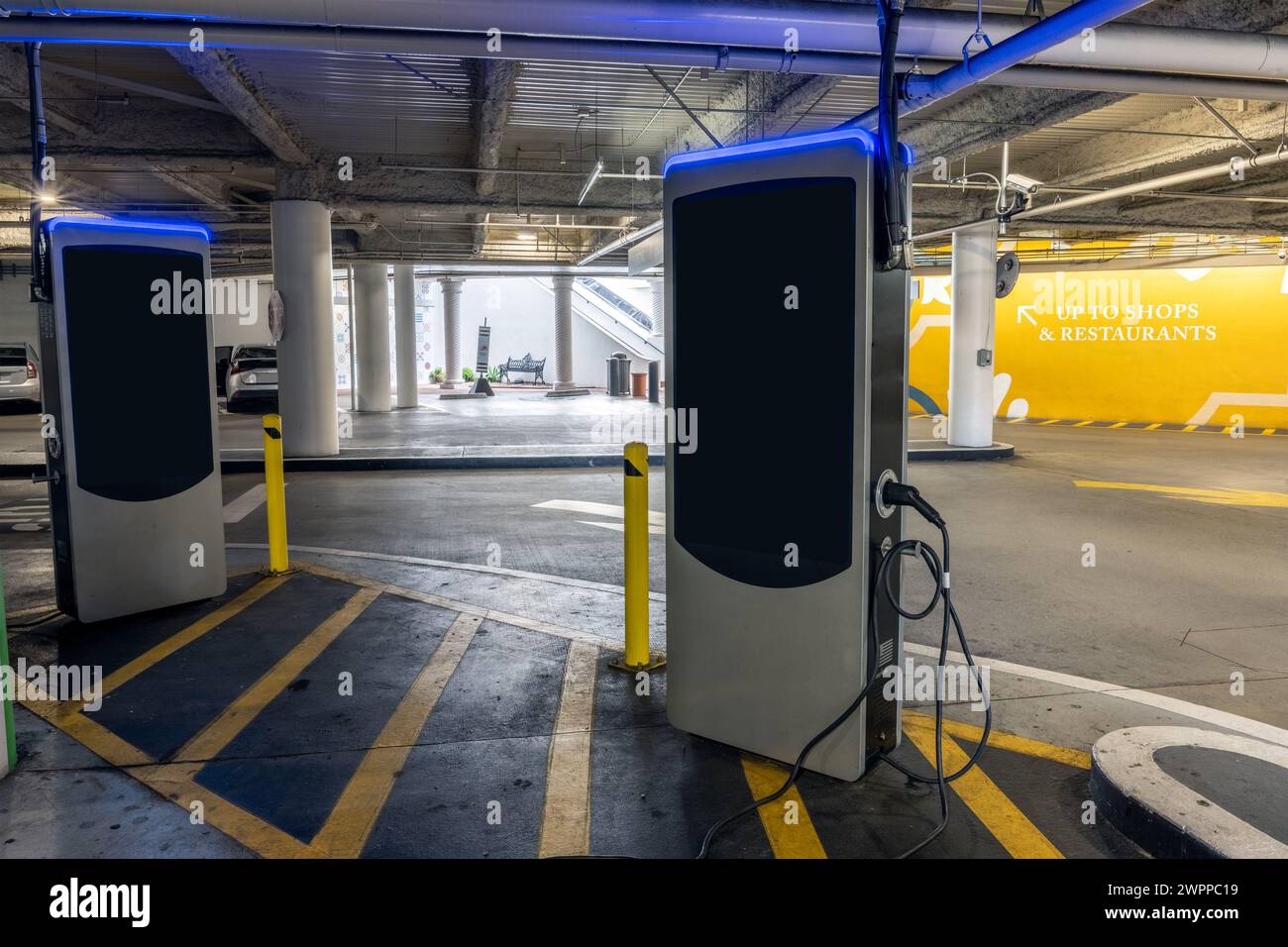 Electric vehicle charging stations at parking structure is conveniently ...