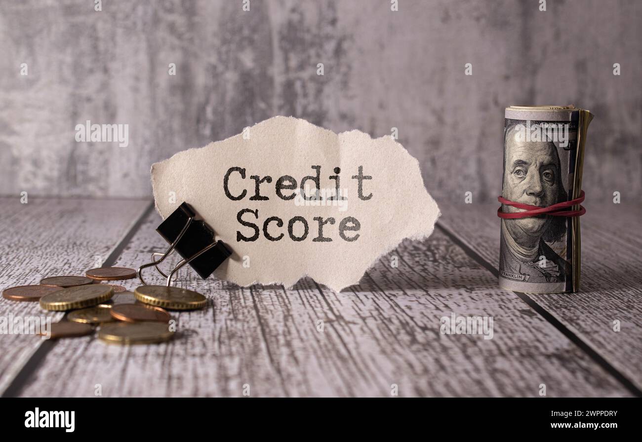 CREDIT SCORE text on a notebook with pen and pencil on grey background ...