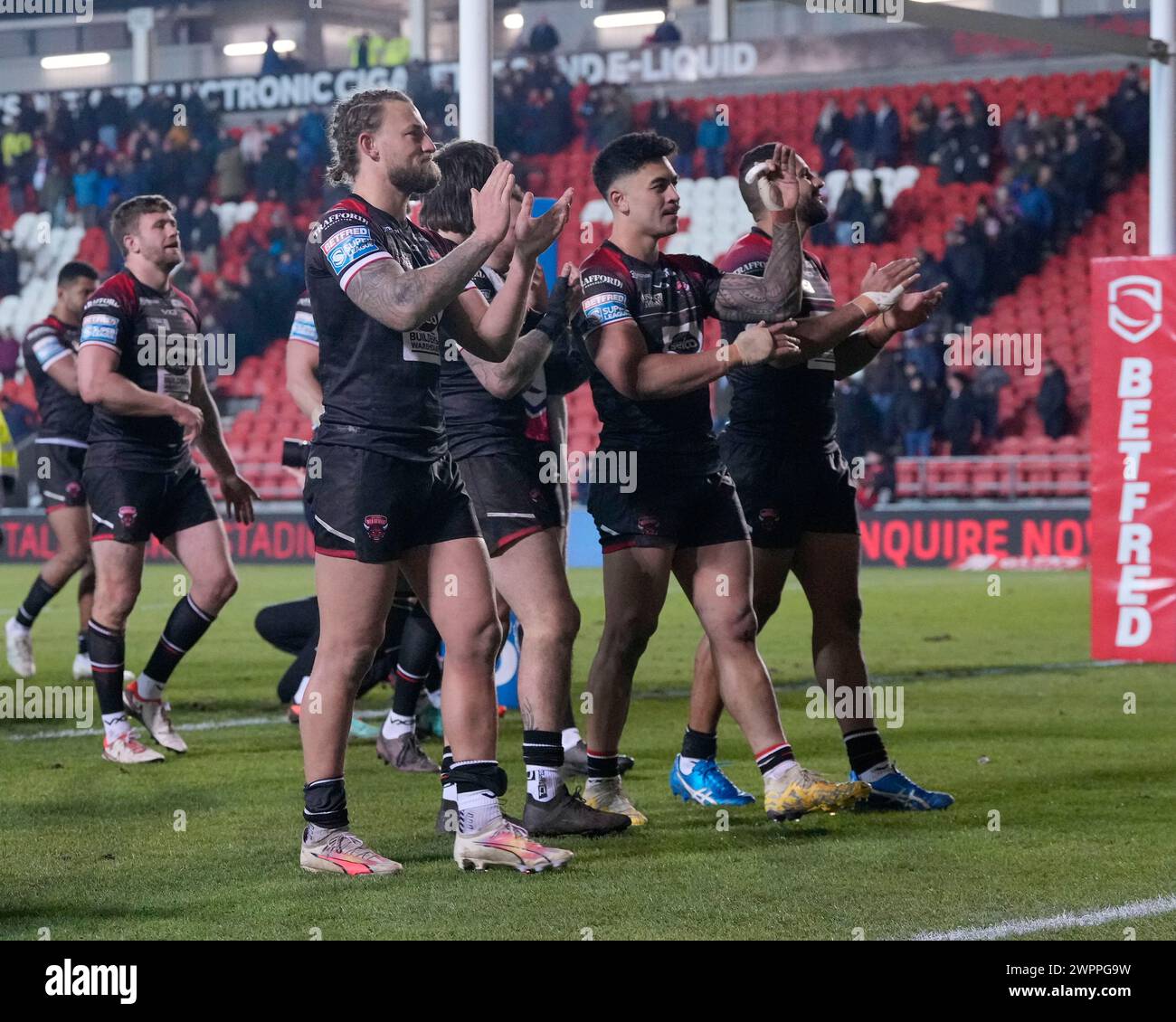 Salford Red Devils players salute their travelling fans after the ...