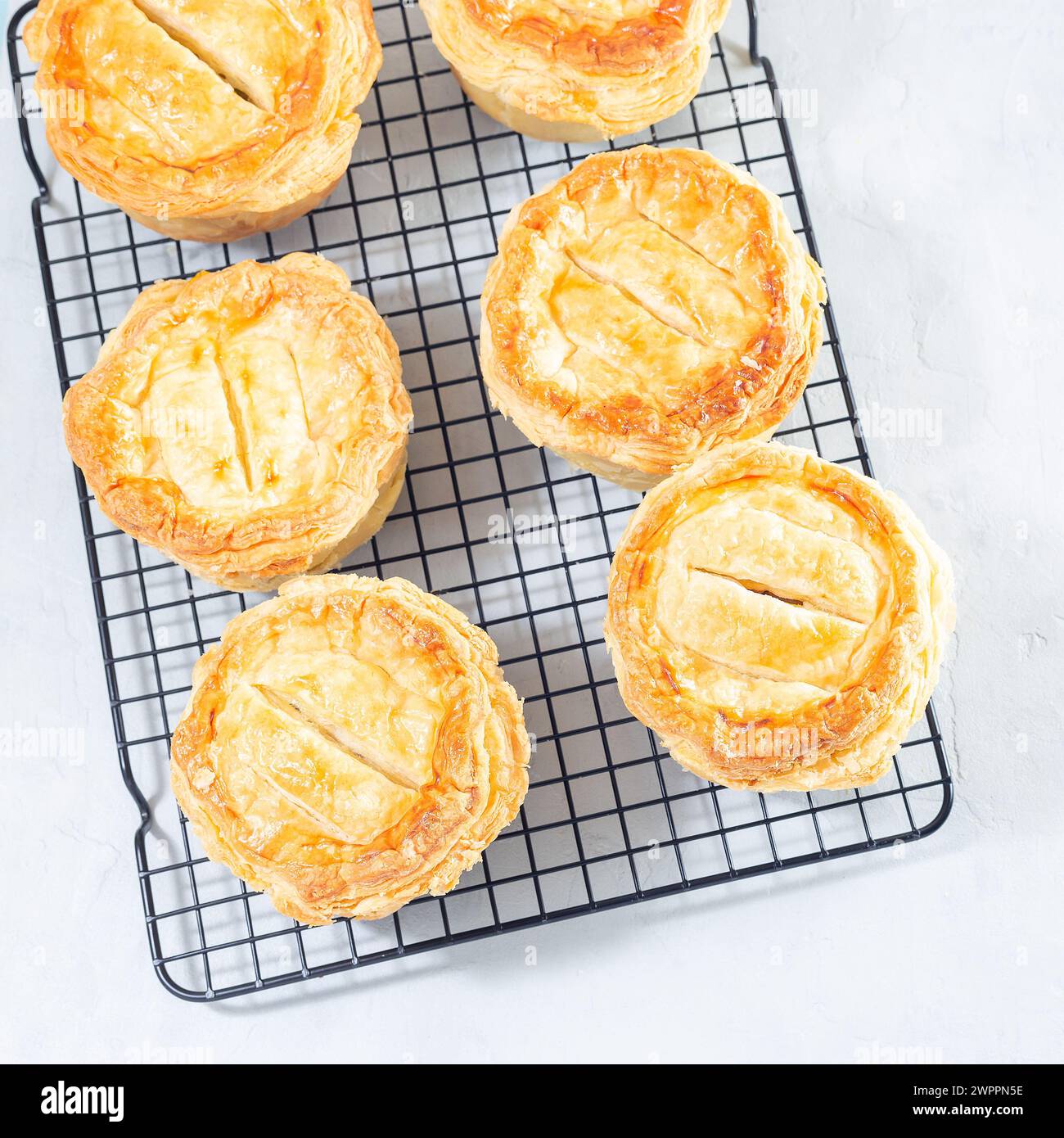 Small beef pot pies cooling rack, top view, square format Stock Photo ...
