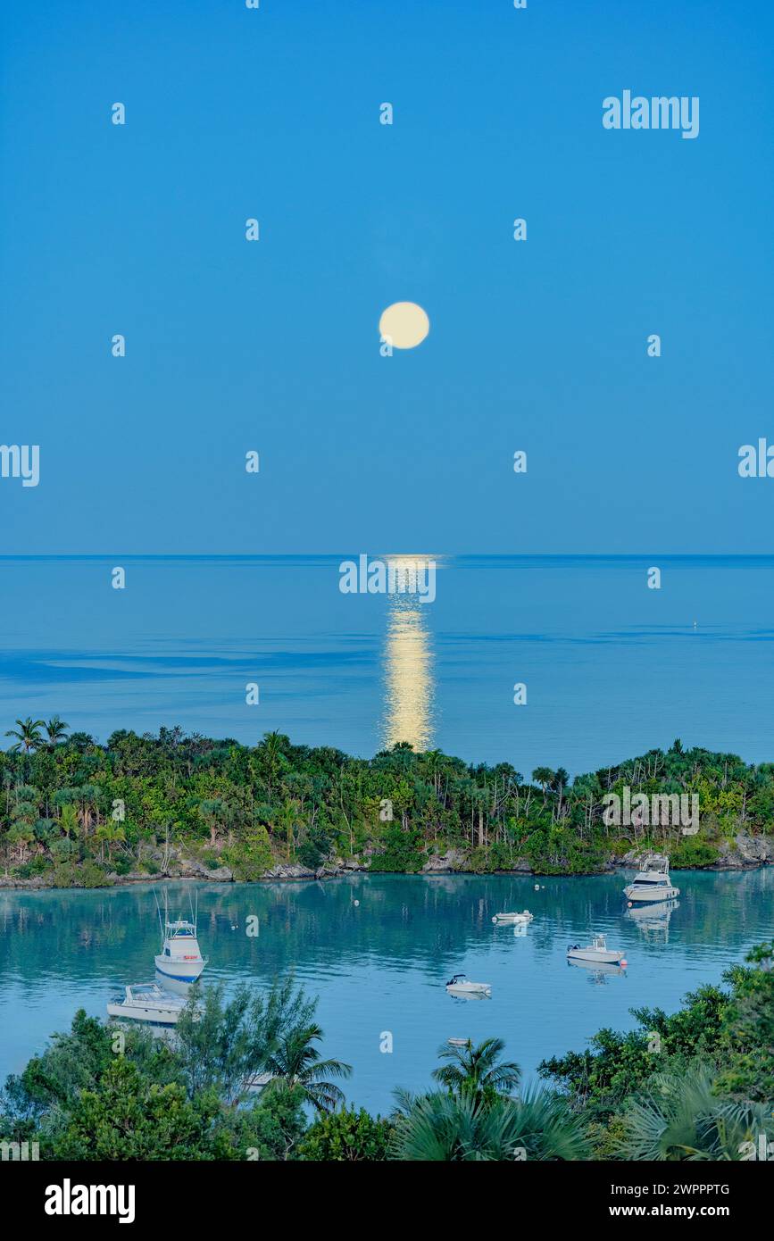 Full Wolf Moon Setting Over Ely's Harbour, Bermuda Stock Photo - Alamy