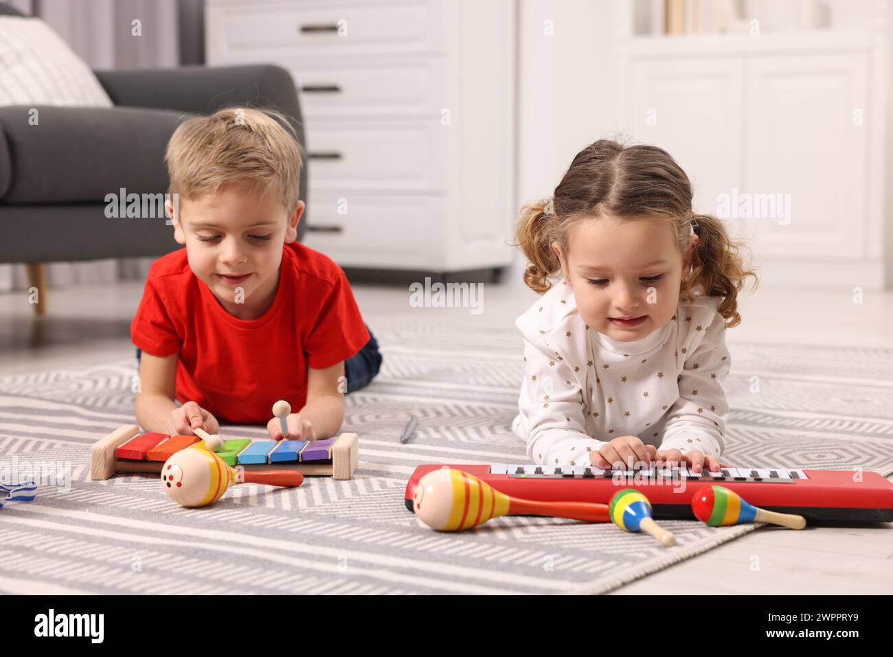 Little children playing toy musical instruments at home Stock Photo - Alamy