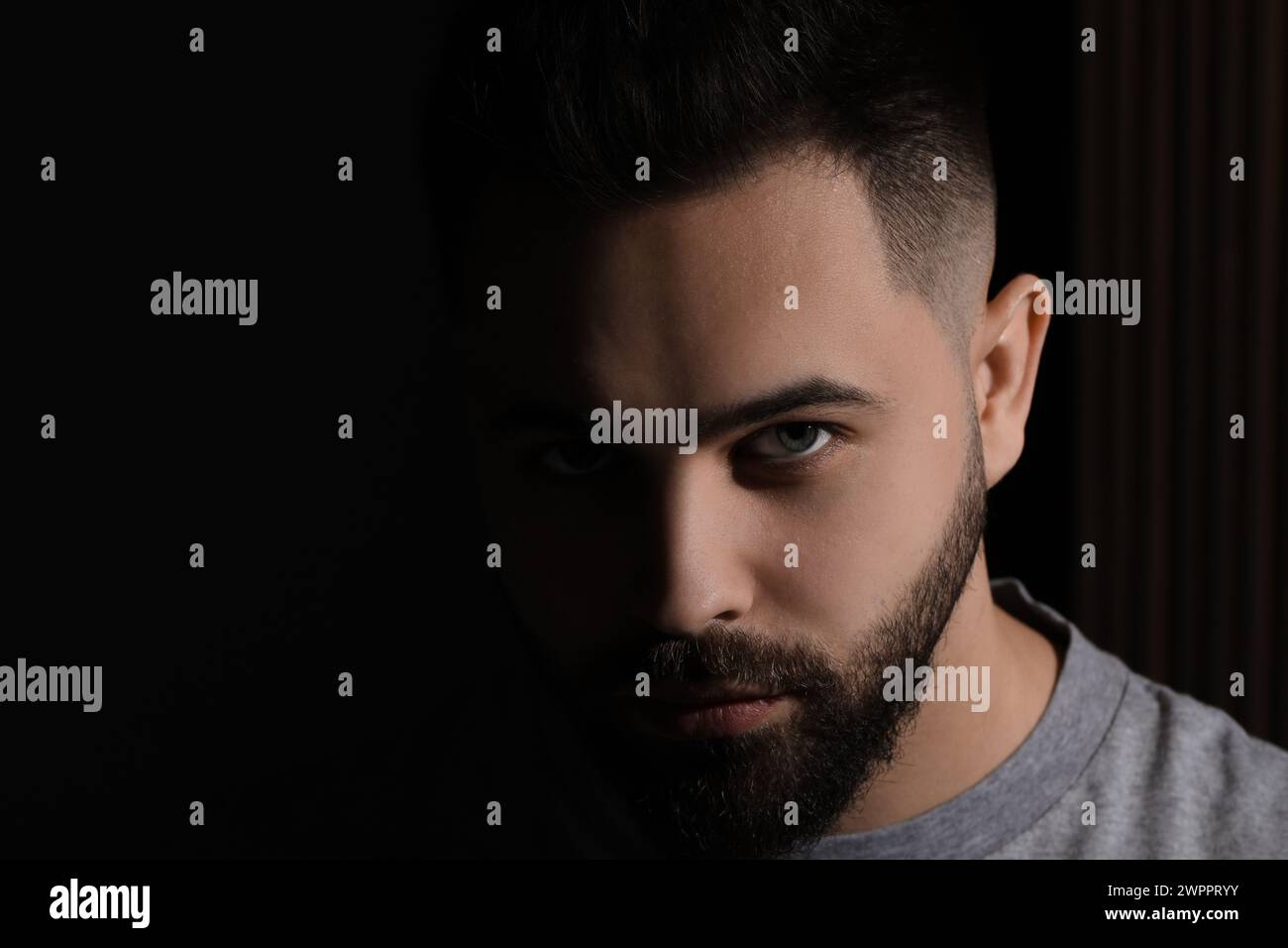 Evil eye. Man with scary eyes on black background, space for text Stock ...