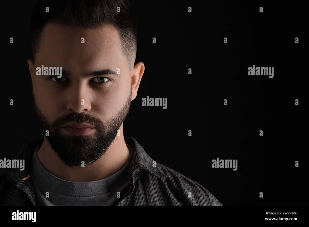 Evil eye. Man with scary eyes on black background, space for text Stock ...