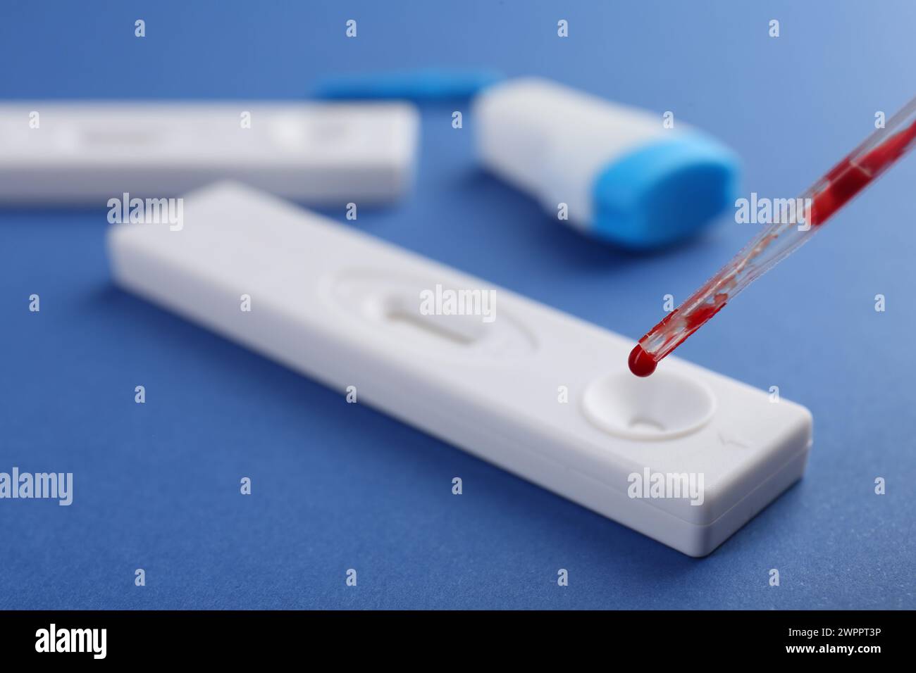 Dropping blood sample onto disposable express test cassette with ...