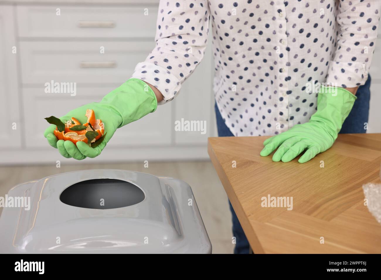 Woman separating garbage wooden hi-res stock photography and images - Alamy