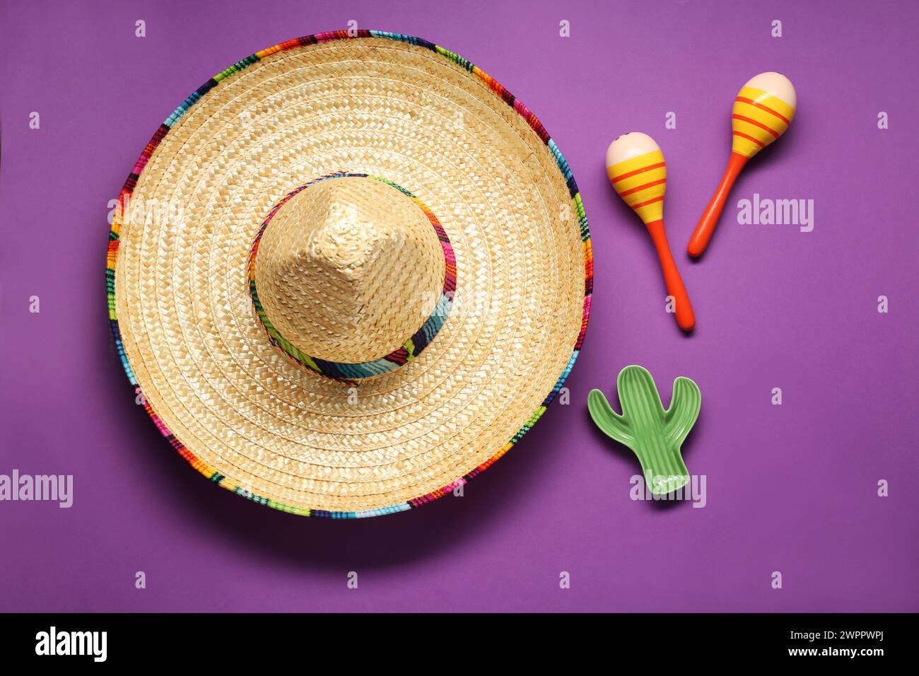 Mexican sombrero hat, maracas and toy cactus on violet background, flat ...