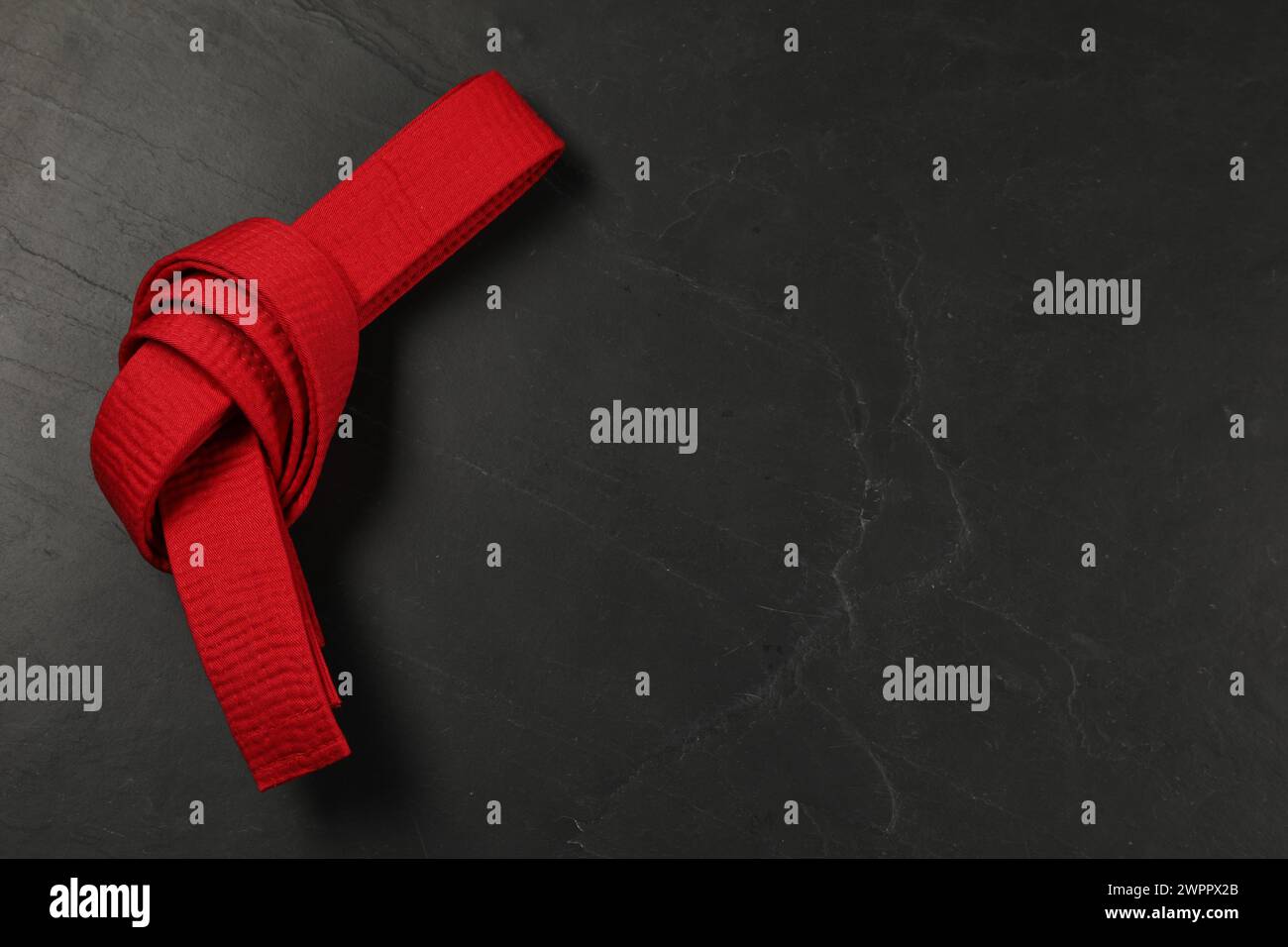 Red karate belt on gray background, top view. Space for text Stock ...