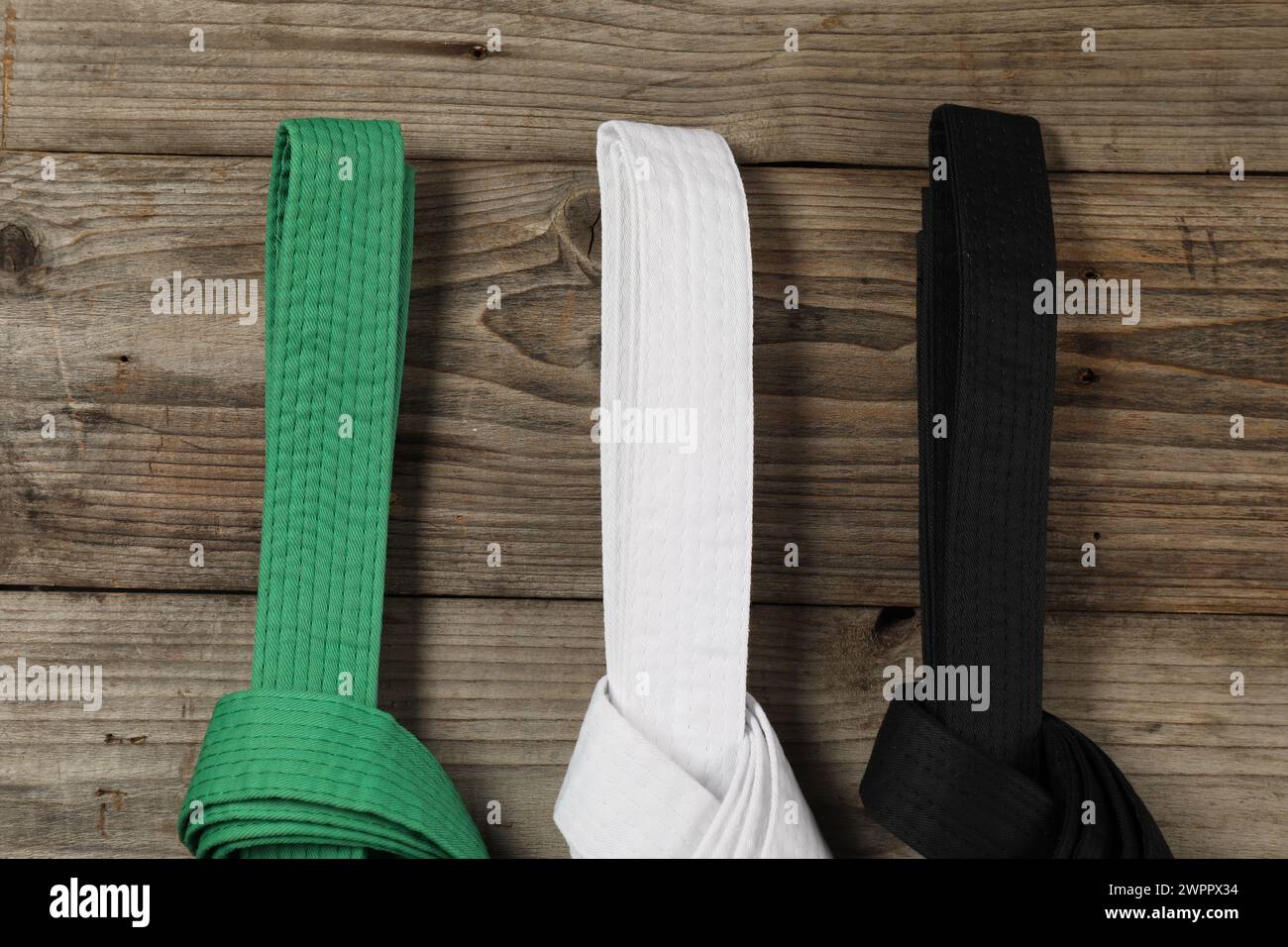 Colorful karate belts on wooden background, flat lay Stock Photo - Alamy