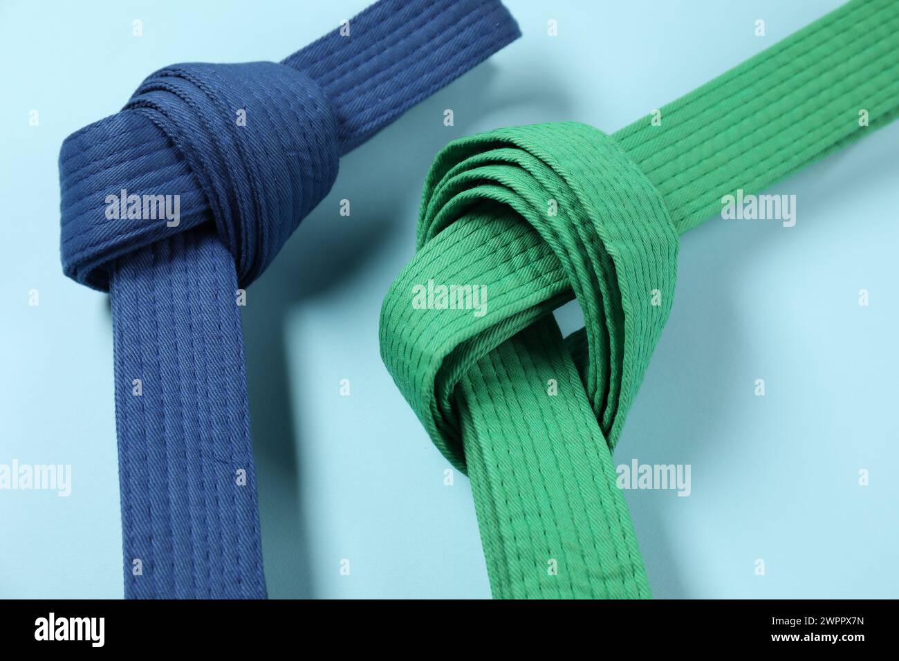 Colorful karate belts on light blue background, closeup Stock Photo - Alamy