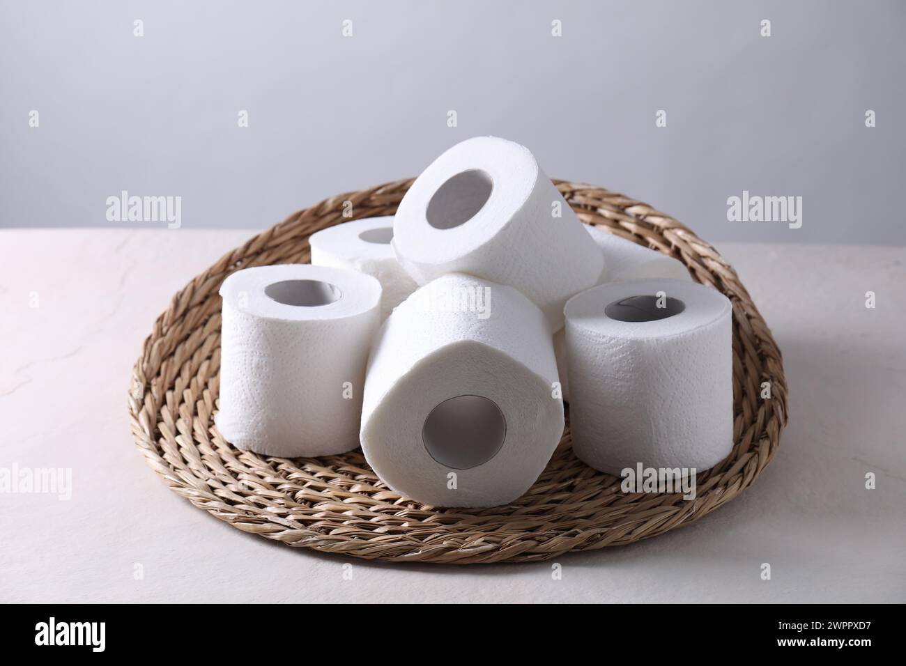 Many toilet paper rolls on white table Stock Photo - Alamy