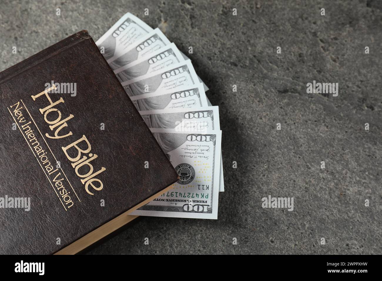 Holy Bible and money on grey table, top view. Space for text Stock ...