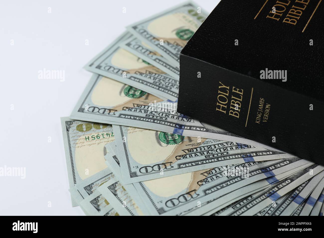 Holy Bible with money on white background, closeup Stock Photo - Alamy