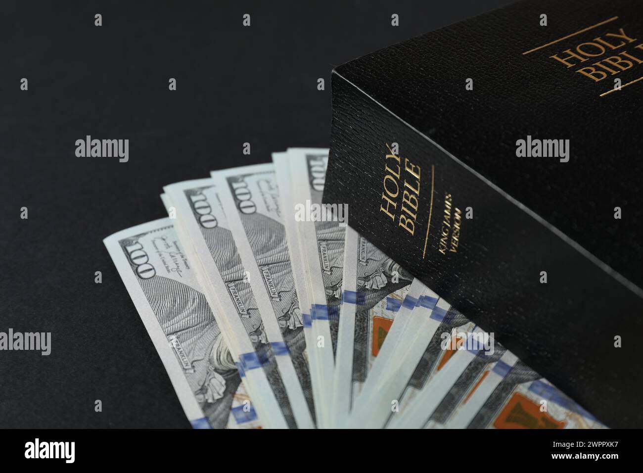Holy Bible with money on black background, closeup Stock Photo - Alamy