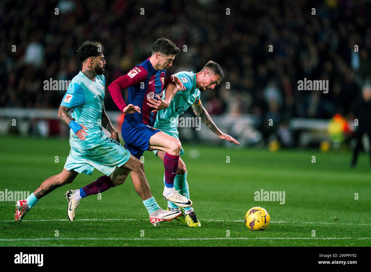 Barceolona. 8th Mar, 2024. Robert Lewandowski (C) of Barcelona vies ...