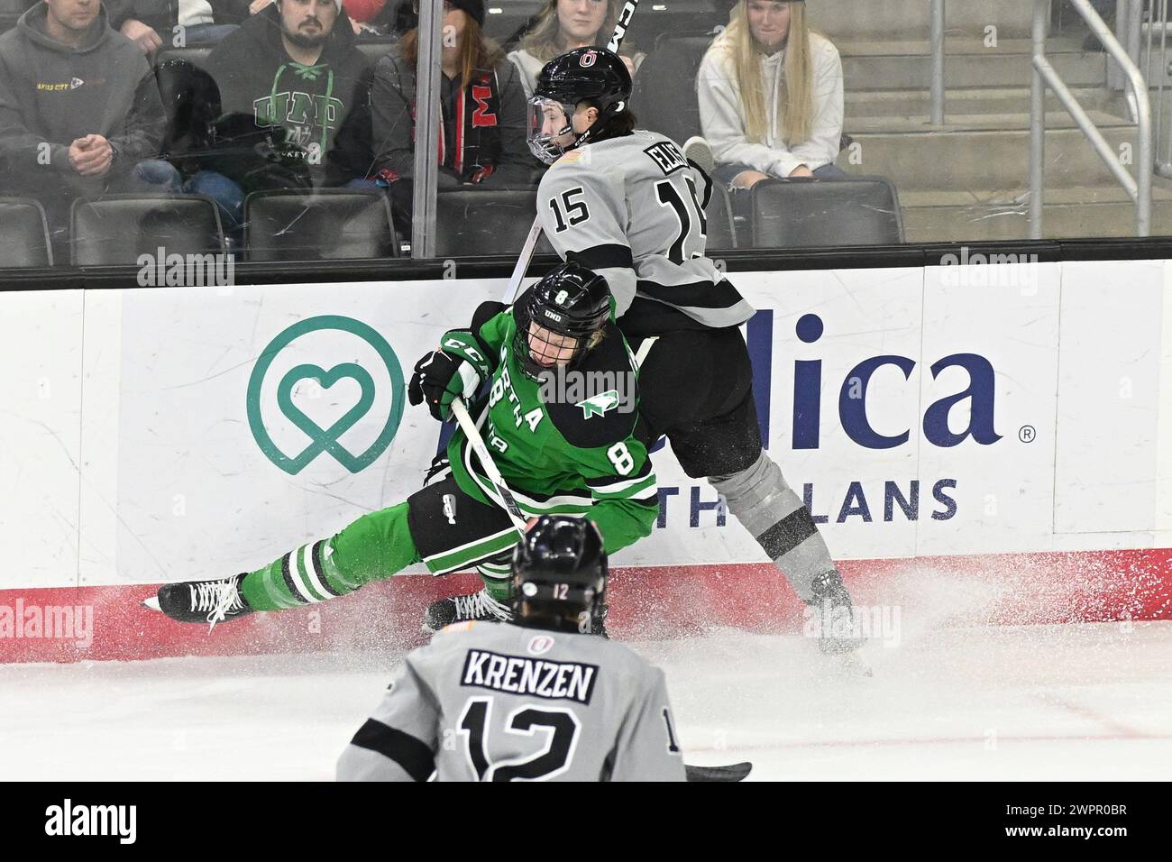 North Dakota Fighting Hawks forward Jake Schmaltz (8) is upended by Omaha Mavericks defenseman ...