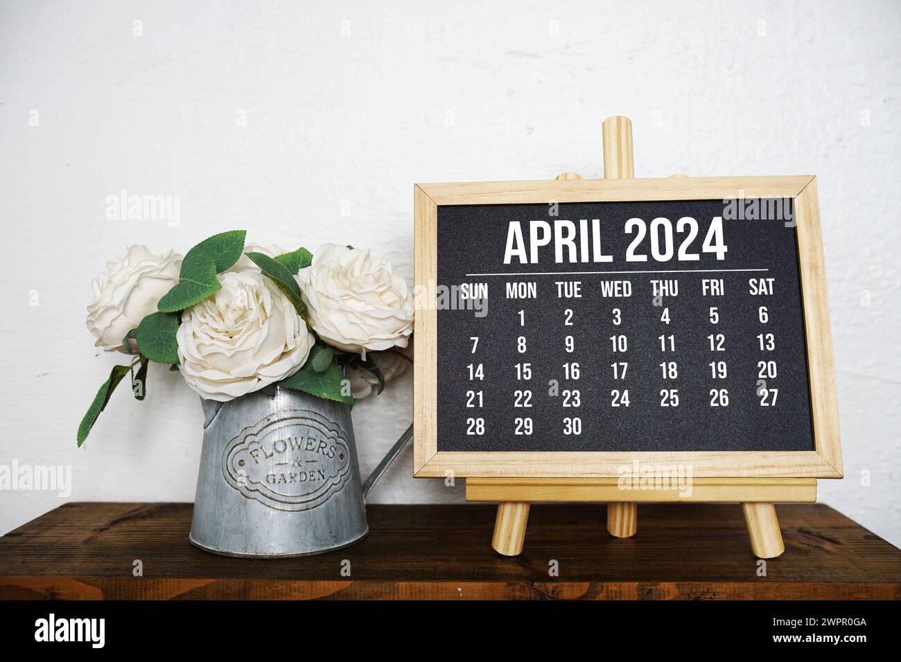 April 2024 monthly calendar with flower bouquet decoration on wooden ...