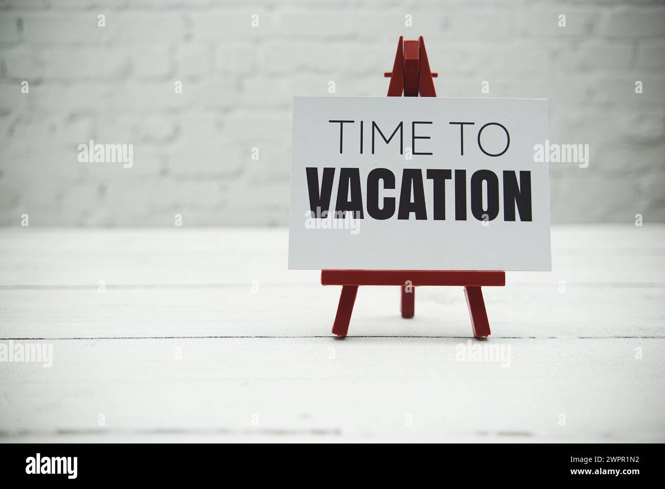 Time to Vacation text on white brick wall and wooden background Stock ...