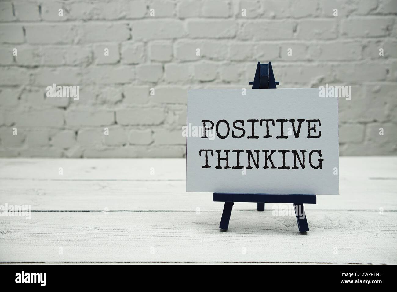 Positive Thinking text on white brick wall and wooden background Stock ...