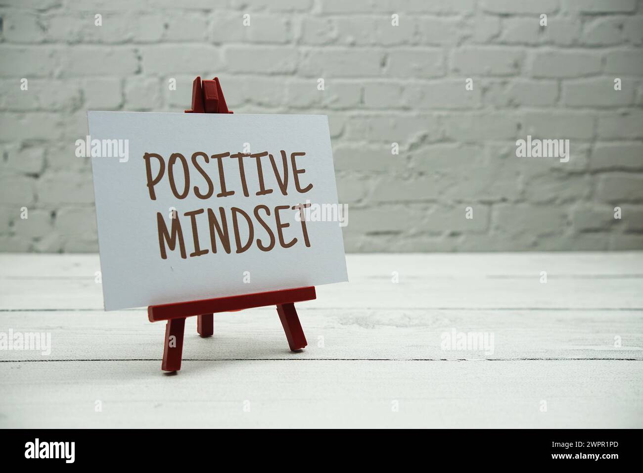 Positive Mindset text on white brick wall and wooden background Stock ...