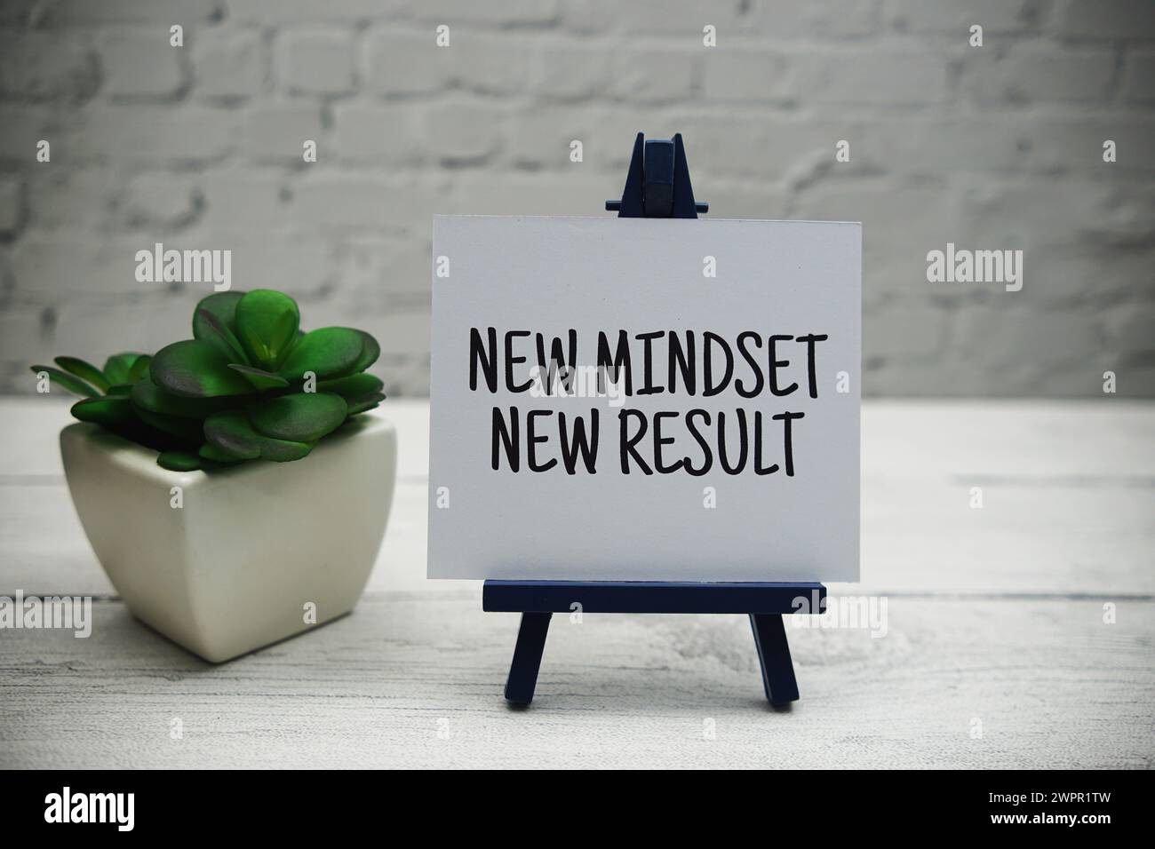 New Mindset New Result text on white brick wall and wooden background Stock Photo - Alamy