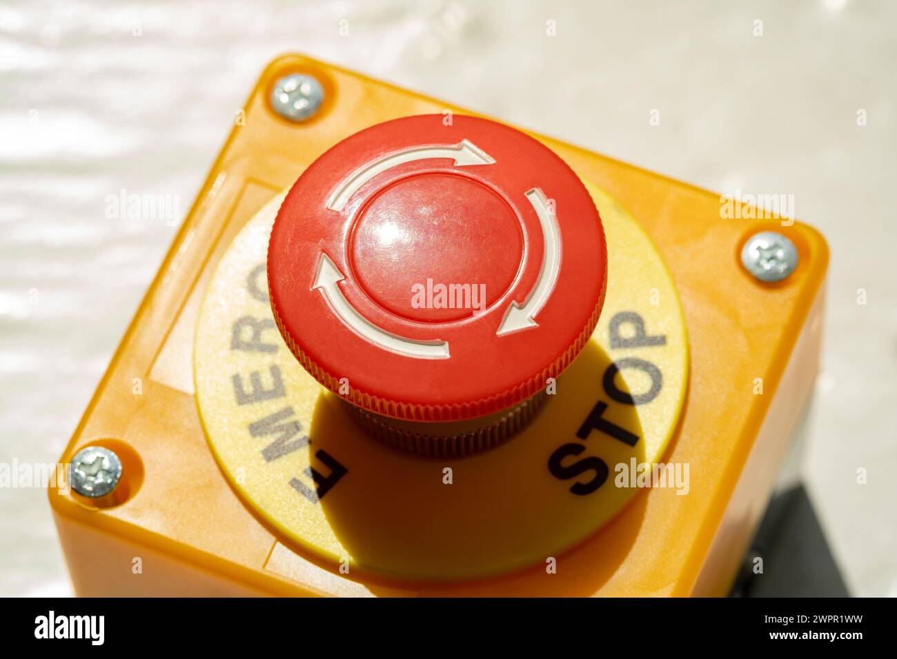 A red Emergency STOP button used for safety on industrial equipment ...