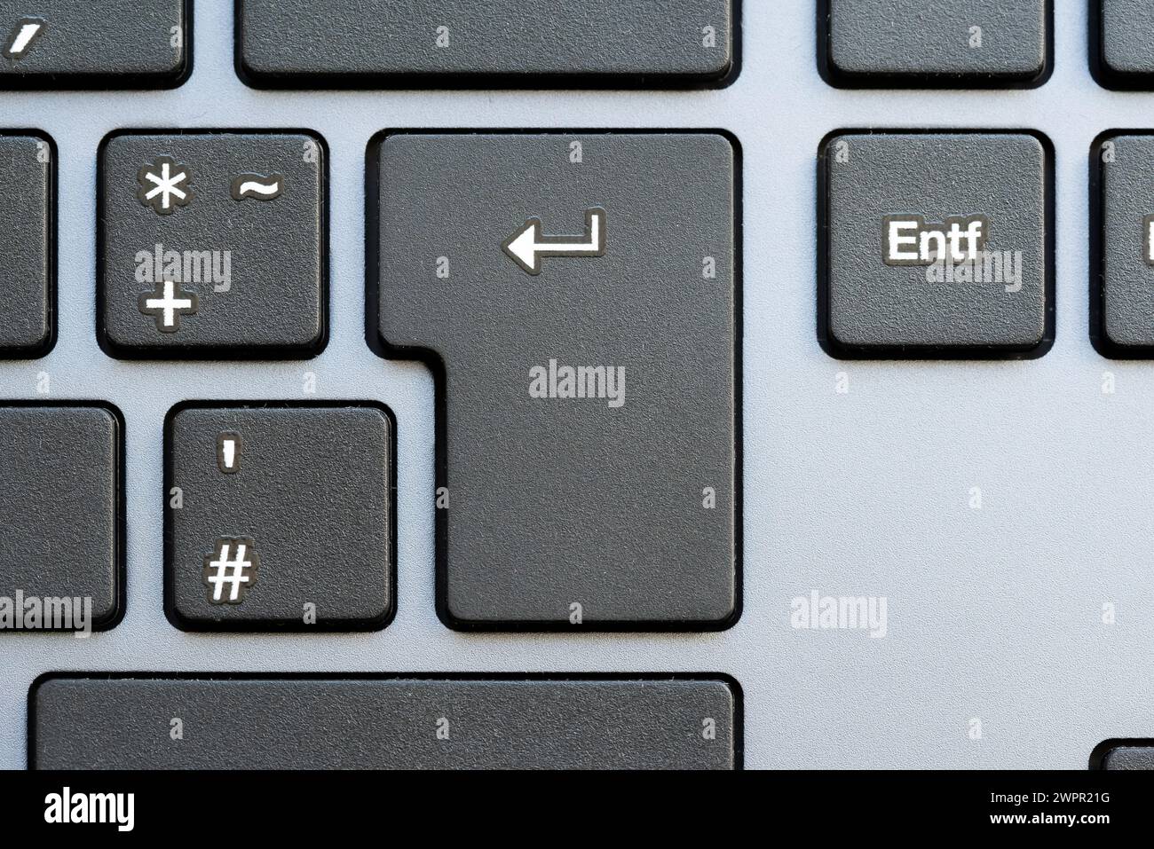 Close-up shot of an Enter key on a modern computer keyboard, completing ...