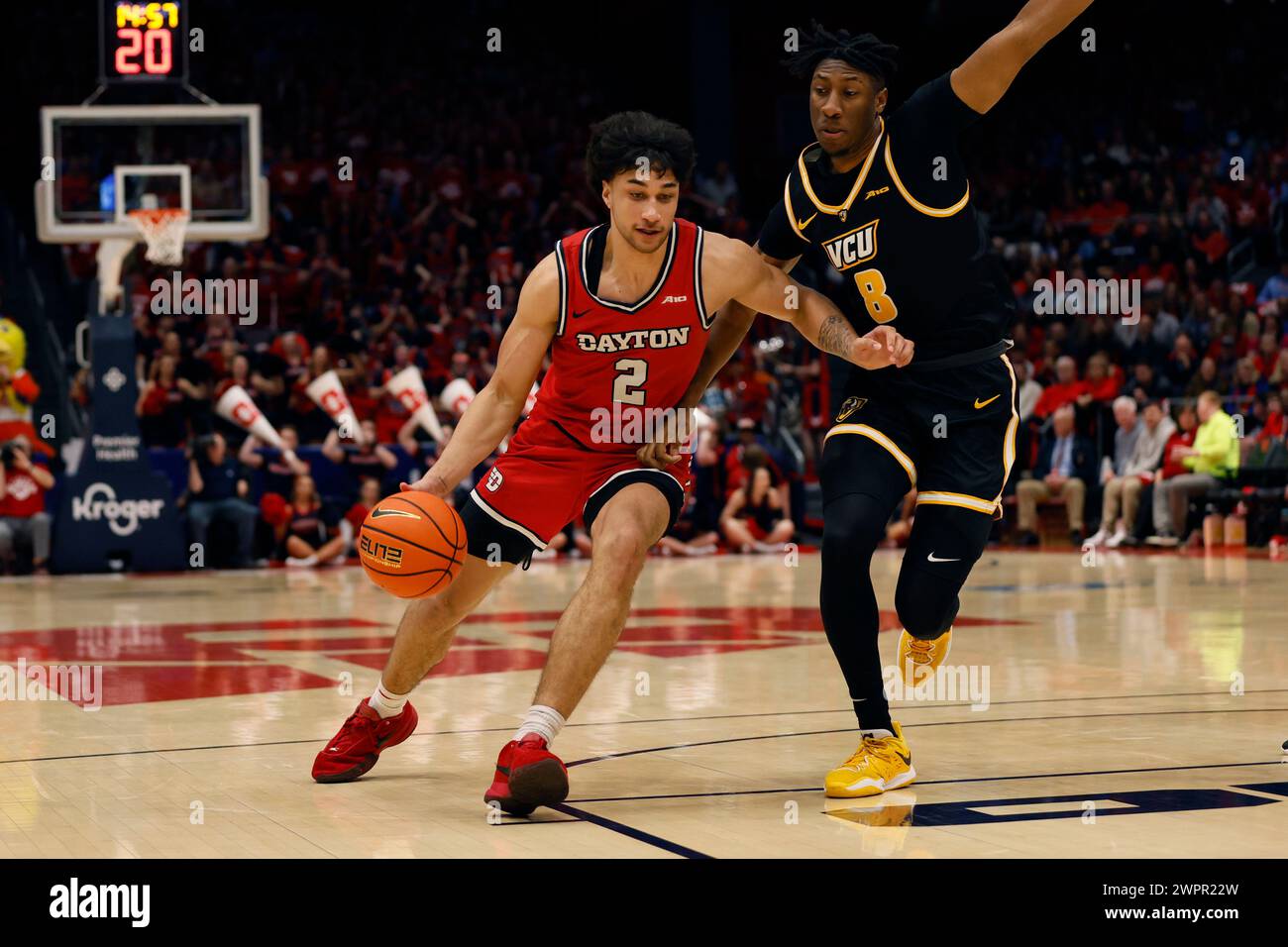 Dayton's Nate Santos, left, drives to the basket against Virginia ...
