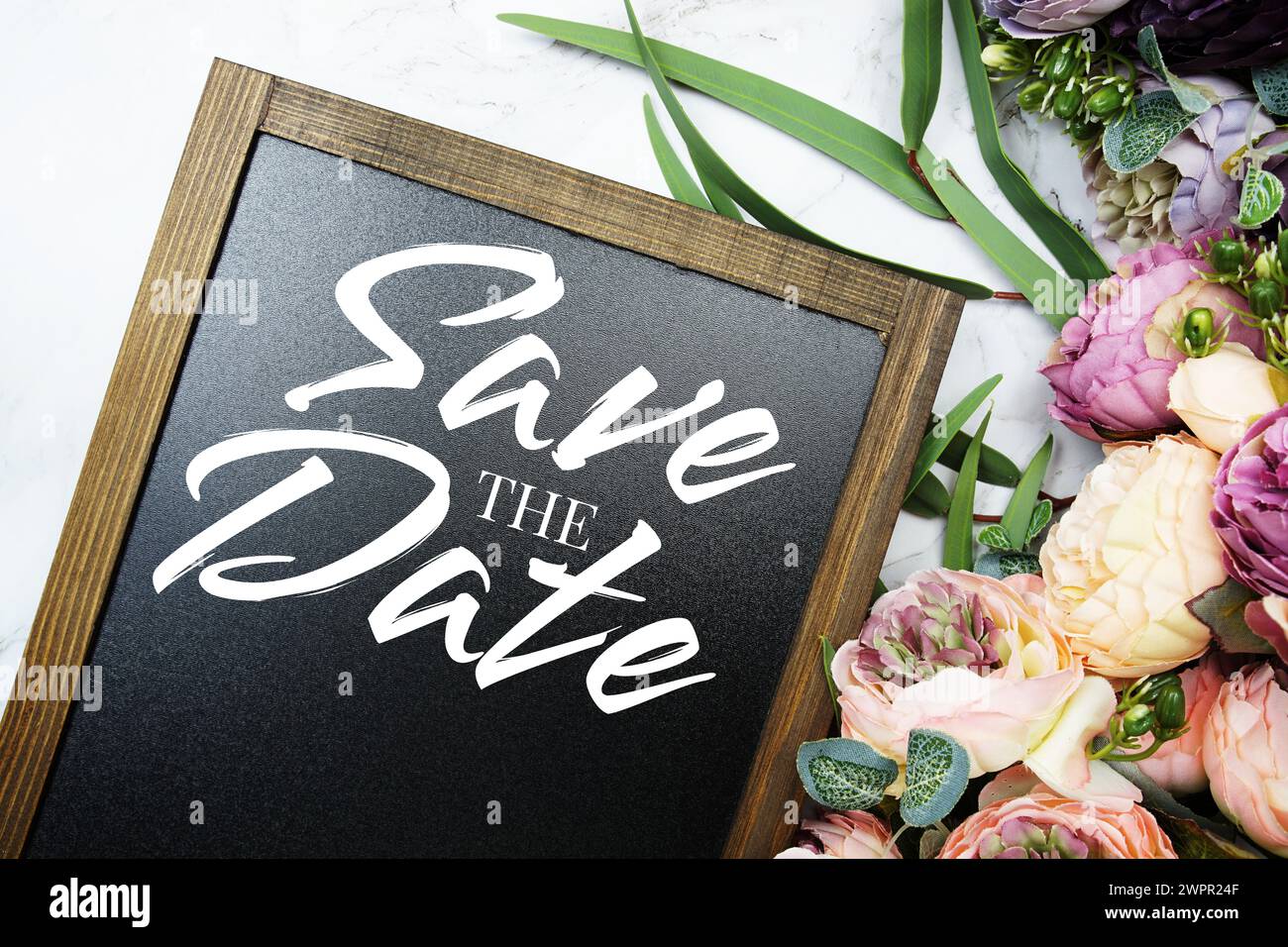 Save the Date text message and eucalyptus leaves decoration on marble ...