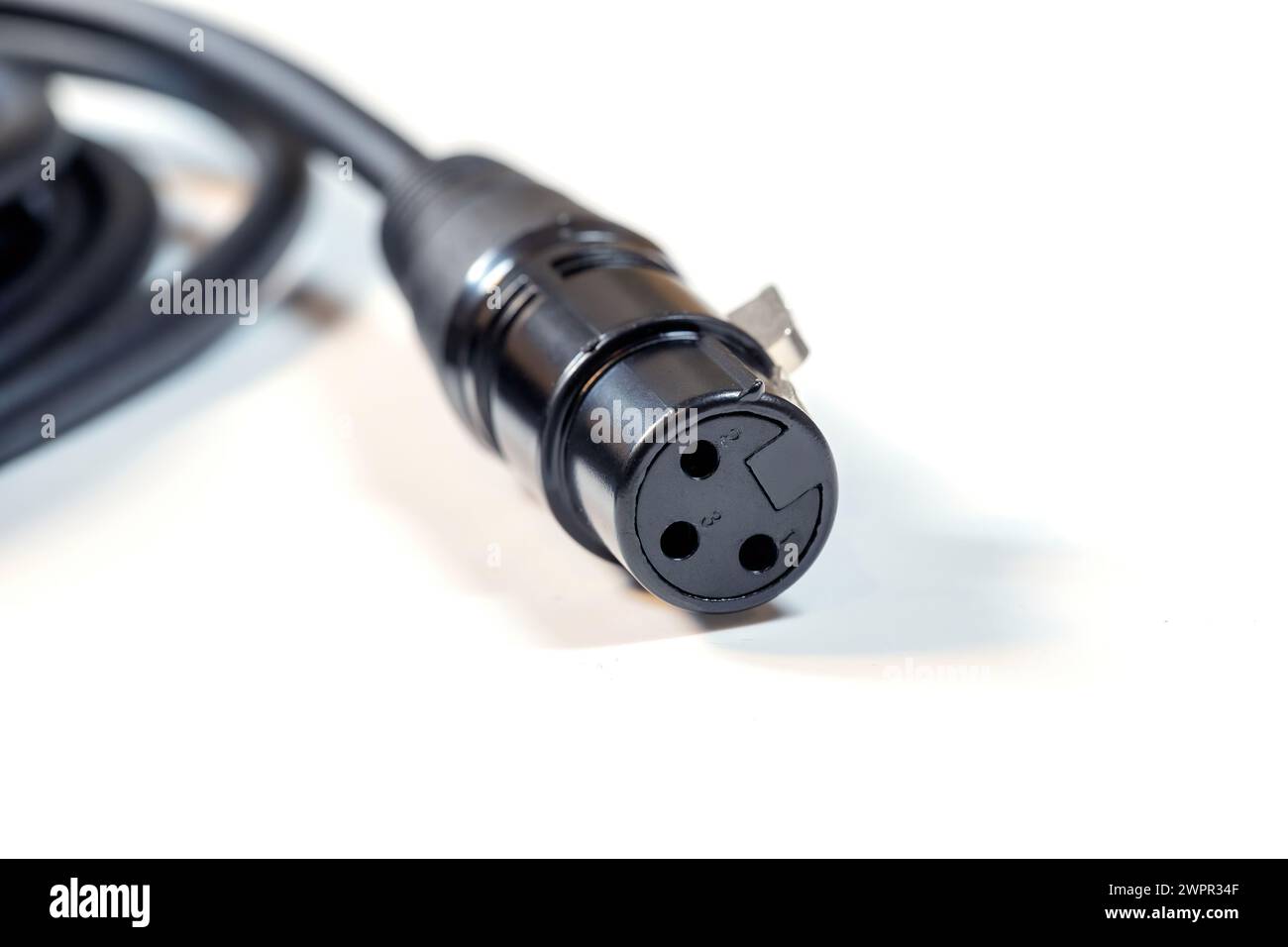 Sharp close-up shot of a three-pin XLR audio cable connector commonly ...