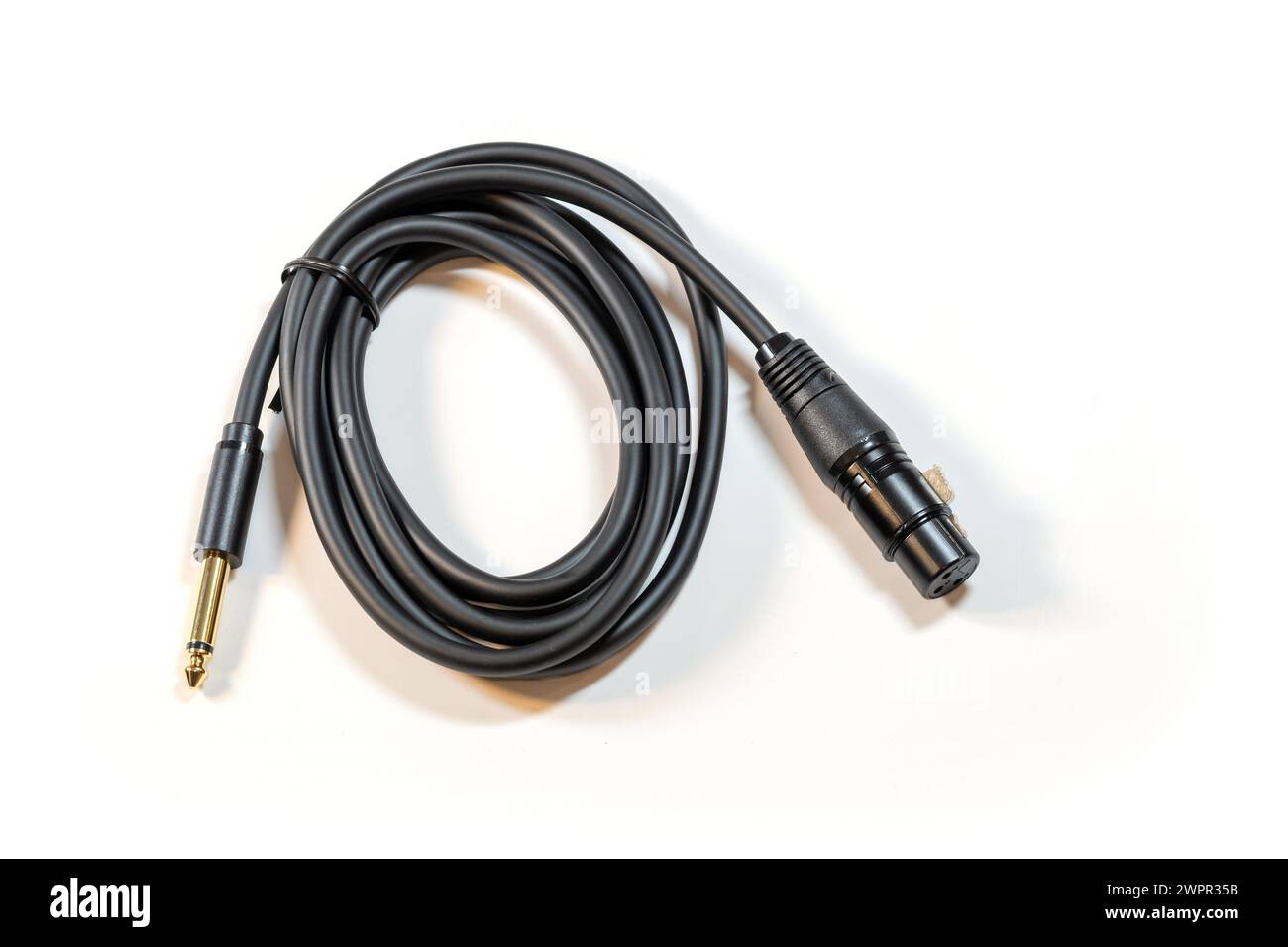 Coiled black audio cable featuring a 1 4 inch jack on one end and an ...