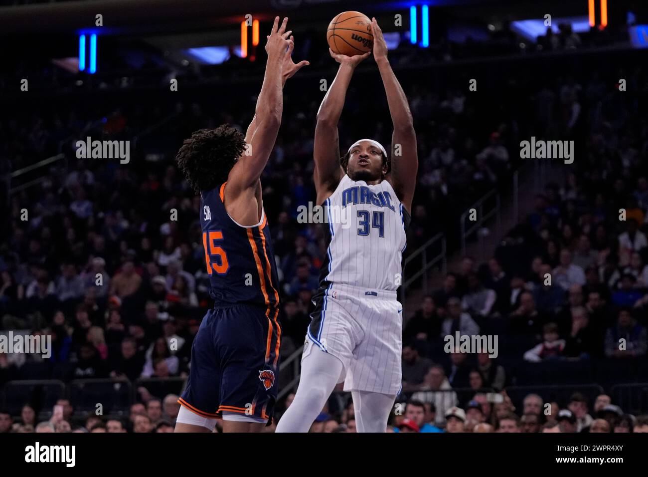Orlando Magic's Wendell Carter Jr. (34) shoots over New York Knicks' Jericho Sims (45) during ...