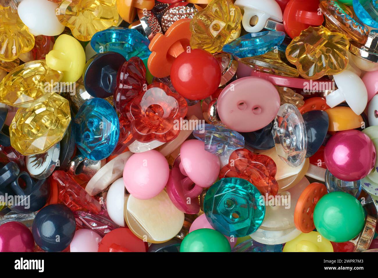 pile of various colors and design buttons, glossy and vibrant colored ...