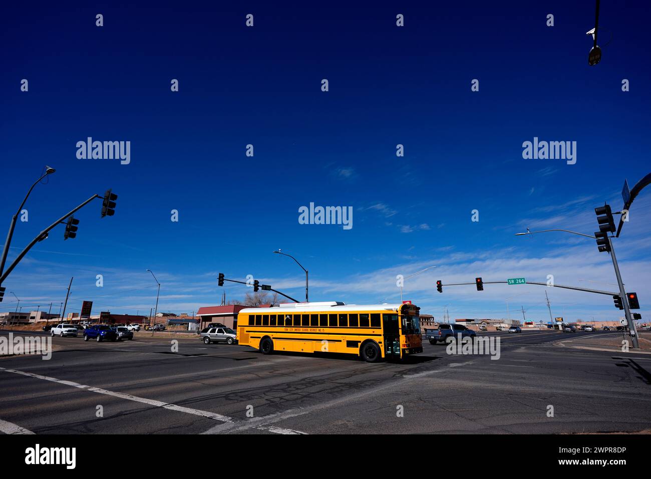 A school bus crosses over Route 160 from the Navajo Nation, left, onto ...