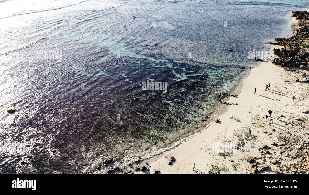 Beautiful Beach, with still water. rocks on the side of the beach and ...