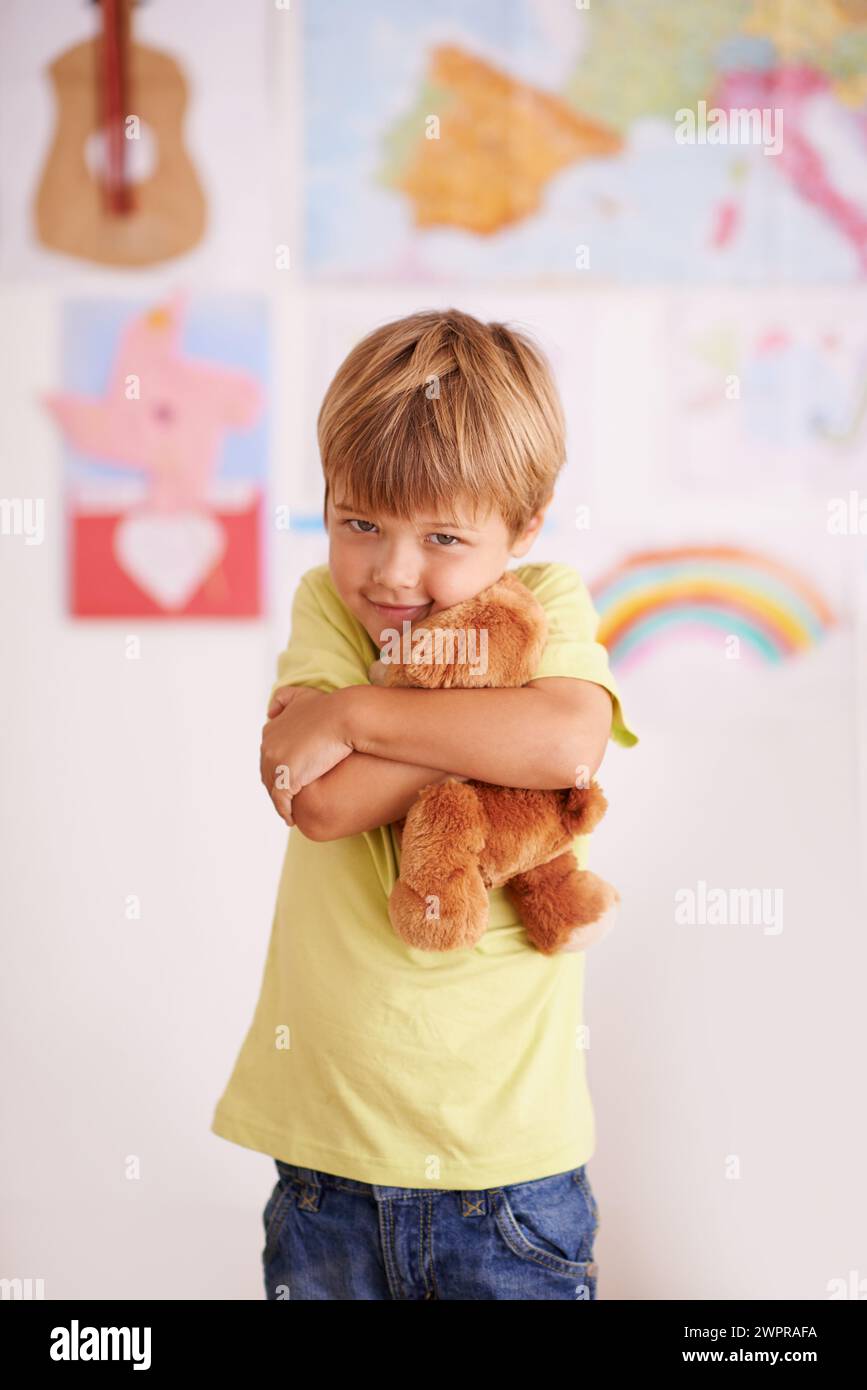 Happy, portrait and child hug teddy bear in kindergarten, class and ...