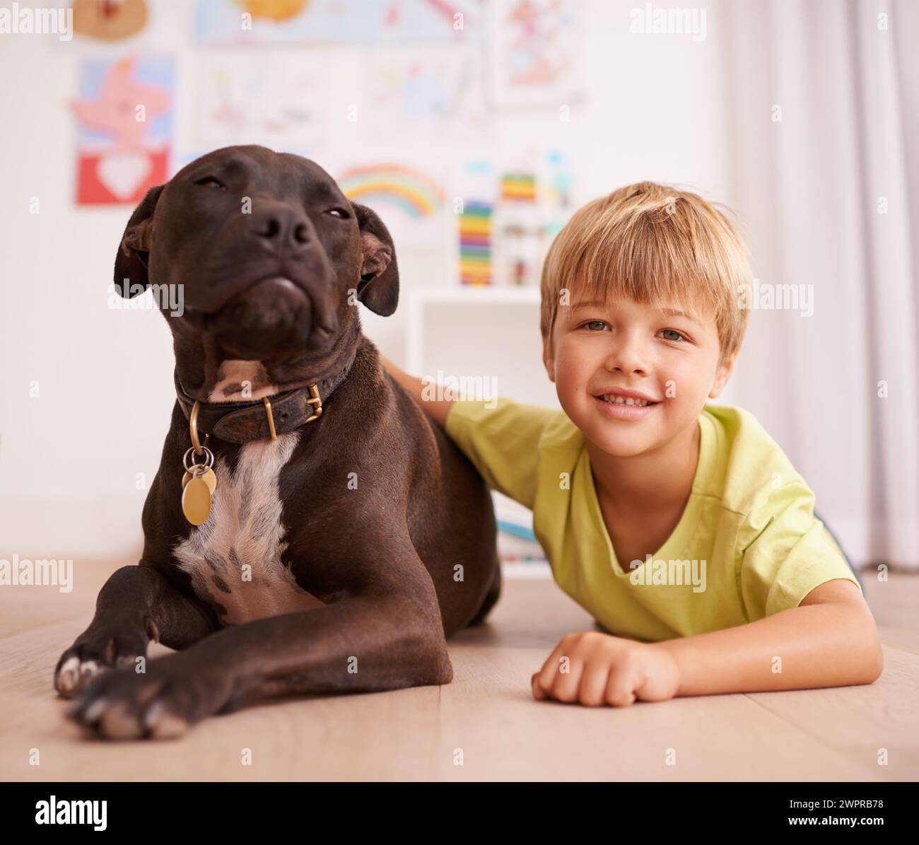 Boy child, dog and portrait, happy with pet and friends in playroom for ...