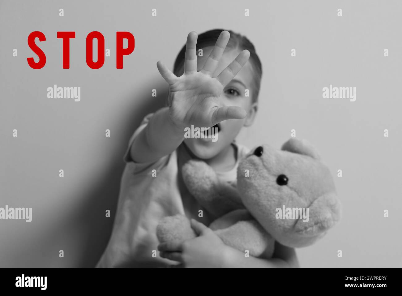 No child abuse. Girl with toy making stop gesture, selective focus ...