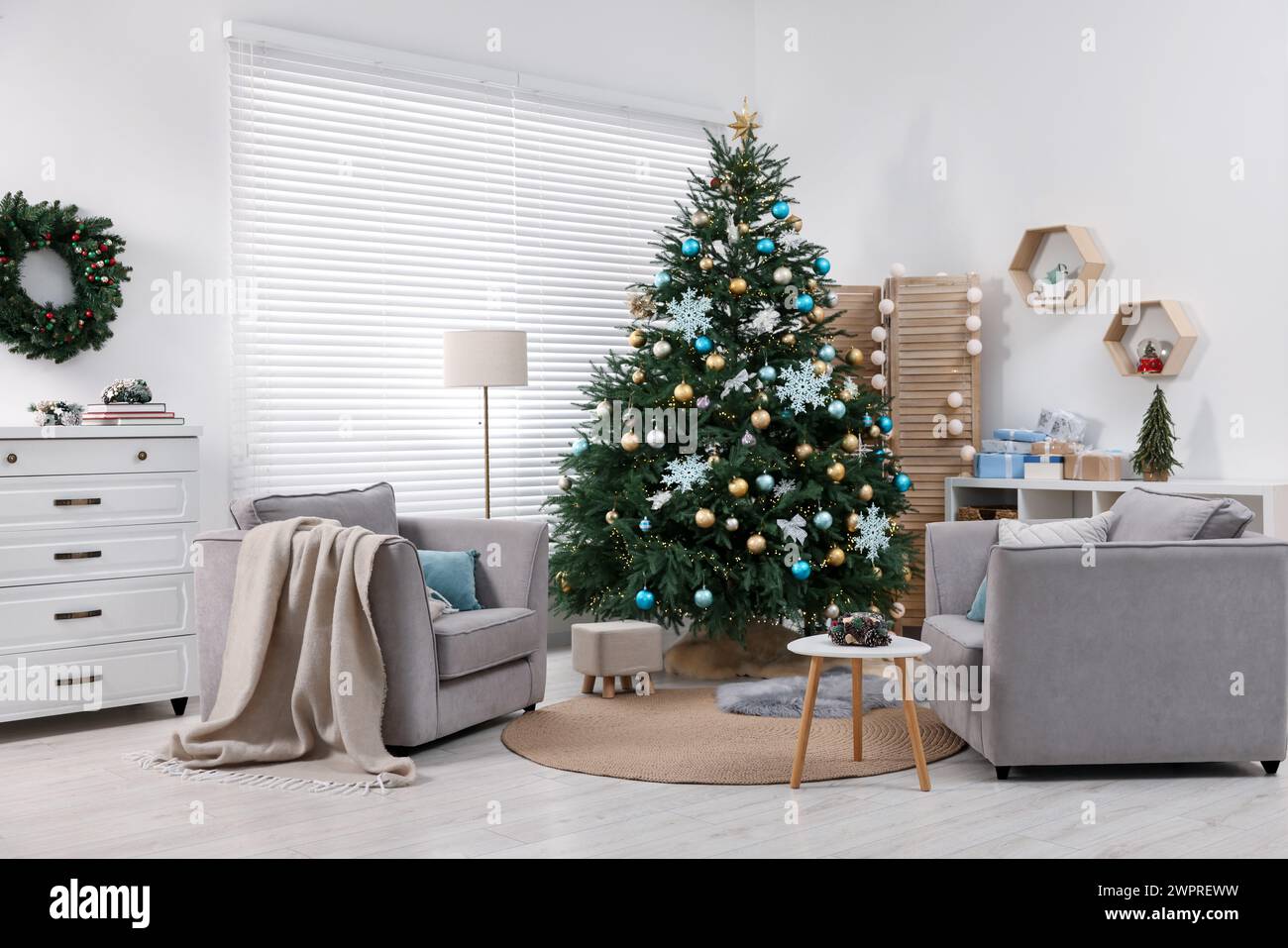 Christmas tree in room decorated for holiday. Festive interior design ...