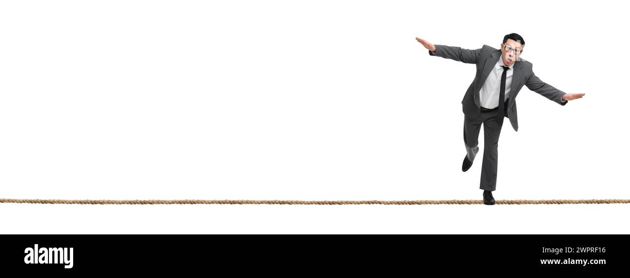 Risks and challenges of owning business. Man balancing on rope against ...