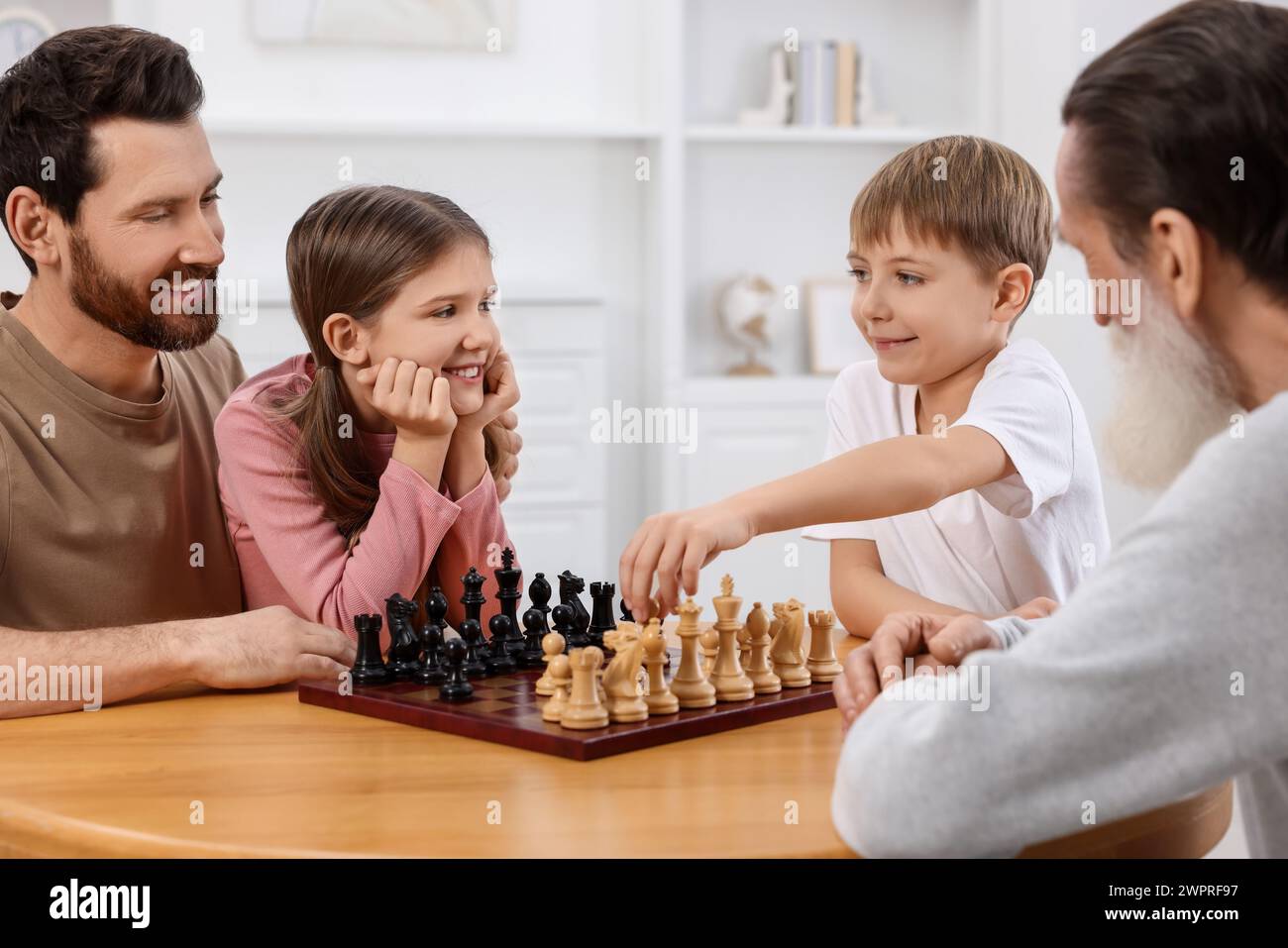 Father grandfather son playing chess hi-res stock photography and ...