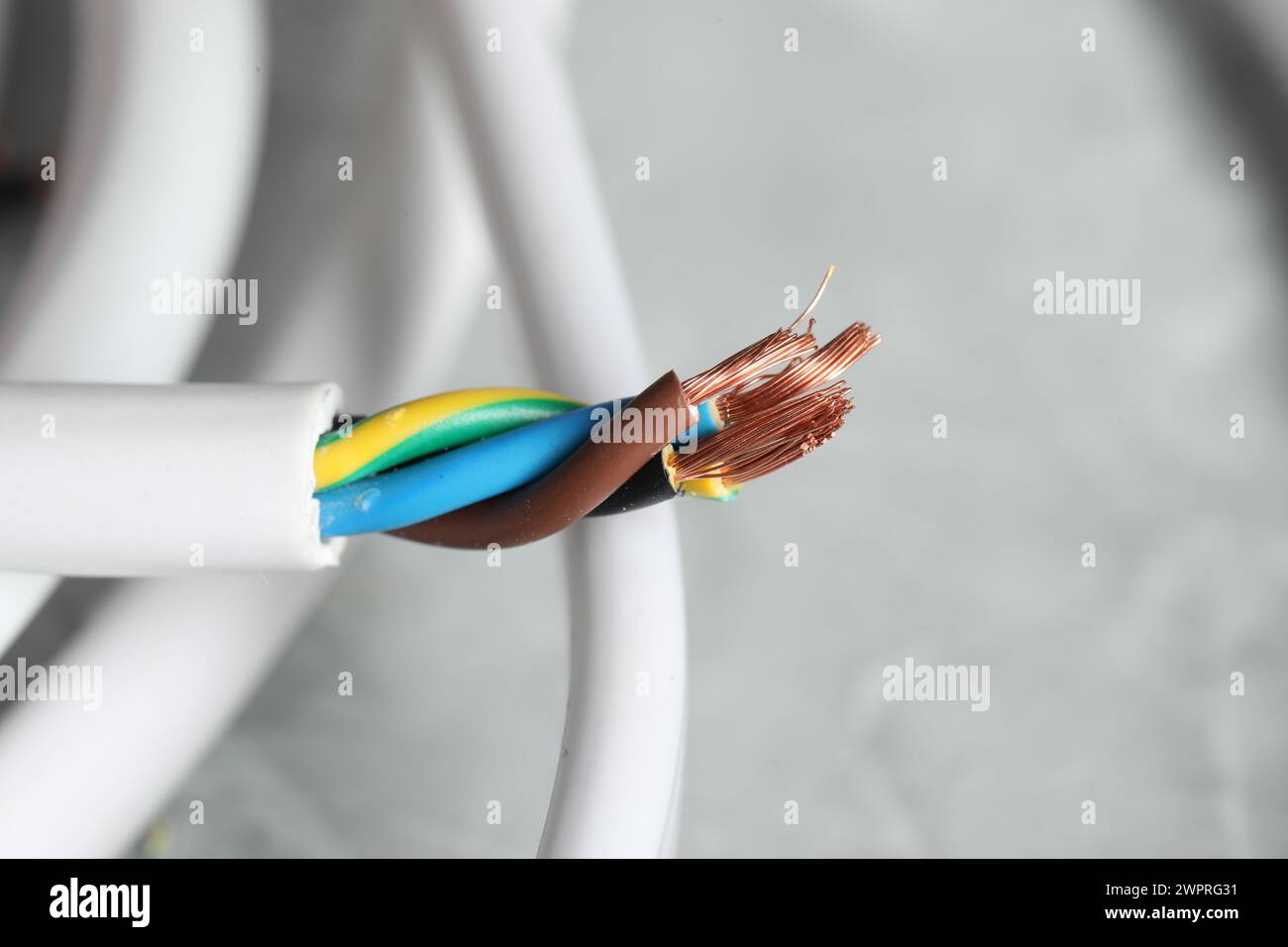 Colorful electrical wire on blurred background, closeup. Space for text ...